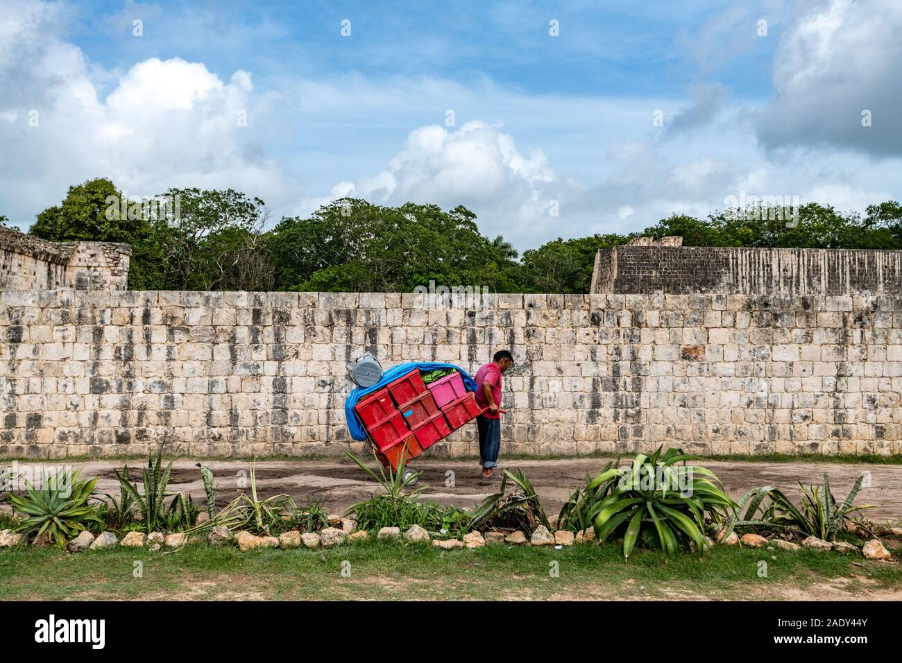 A man pulls a heavy cart full of tourist merchandise infront of The ...