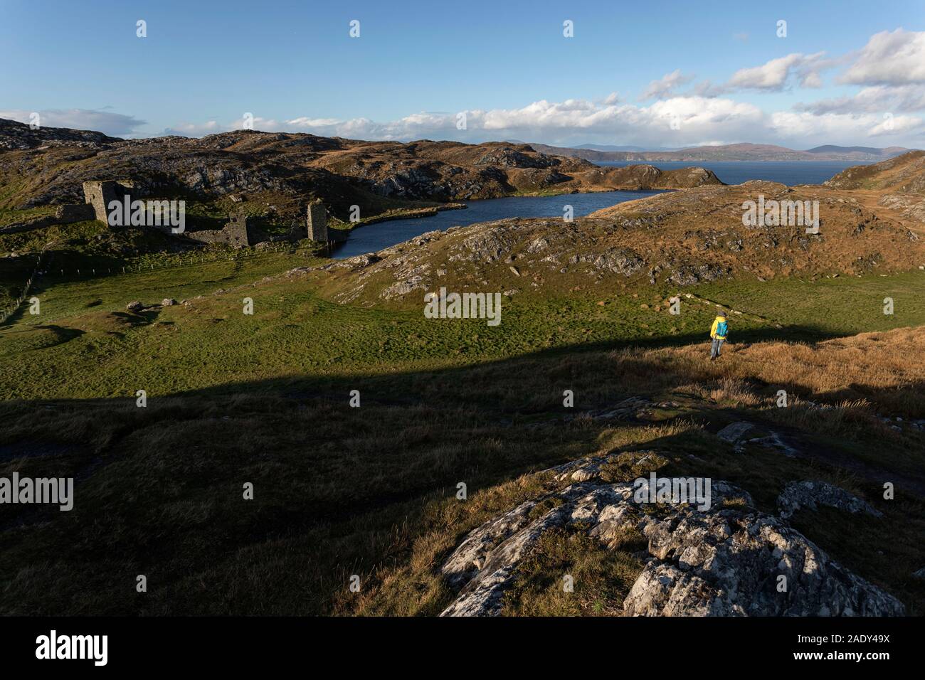 Mother and son hiking to castle ruins, Scenic sight of Dunlough Castle ...