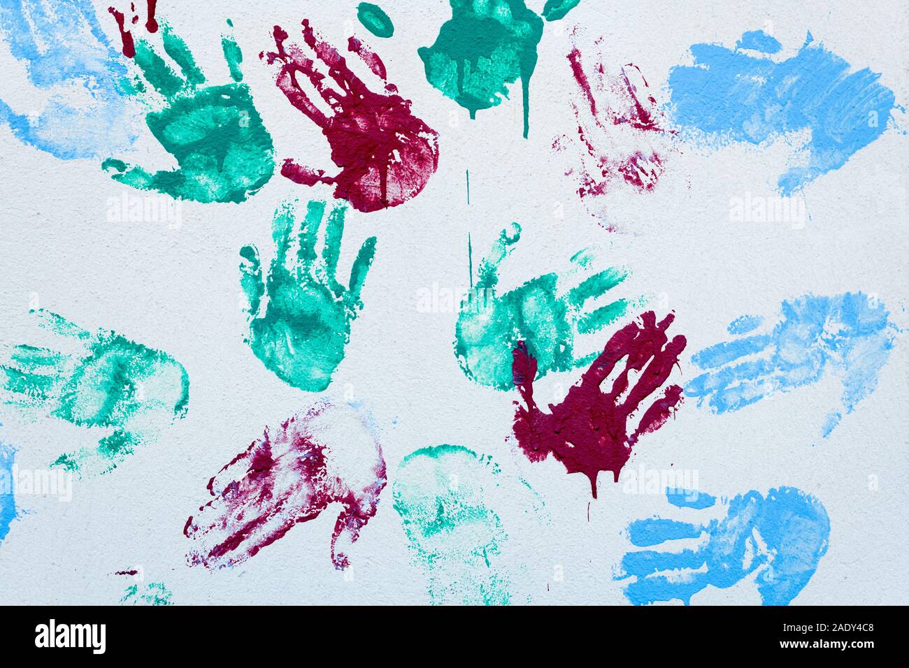 colorful hand prints on a white wall, made by children Stock Photo - Alamy