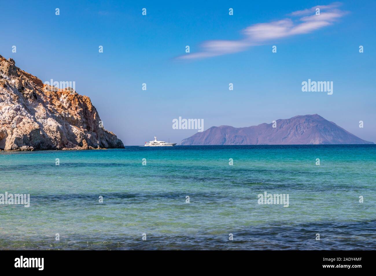 Plathiena beach with cliffs, island and a Yacht, Milos, Greece Stock ...