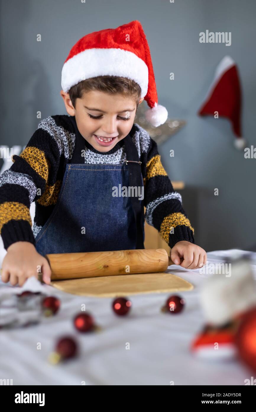 Beautiful boy making cookies on Christmas Day Stock Photo - Alamy