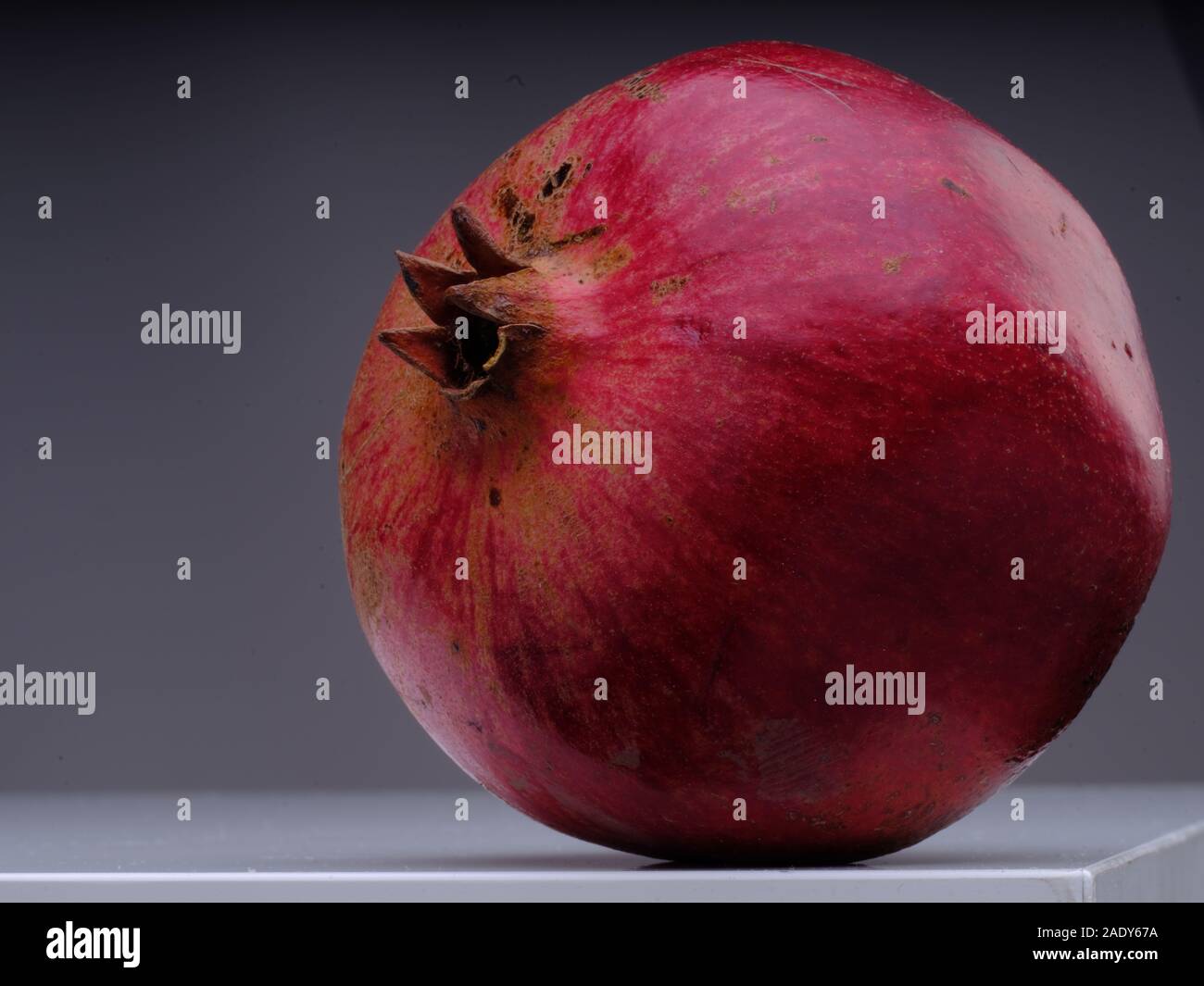 Close up high resolution organic pomegranate on a grey background Stock ...