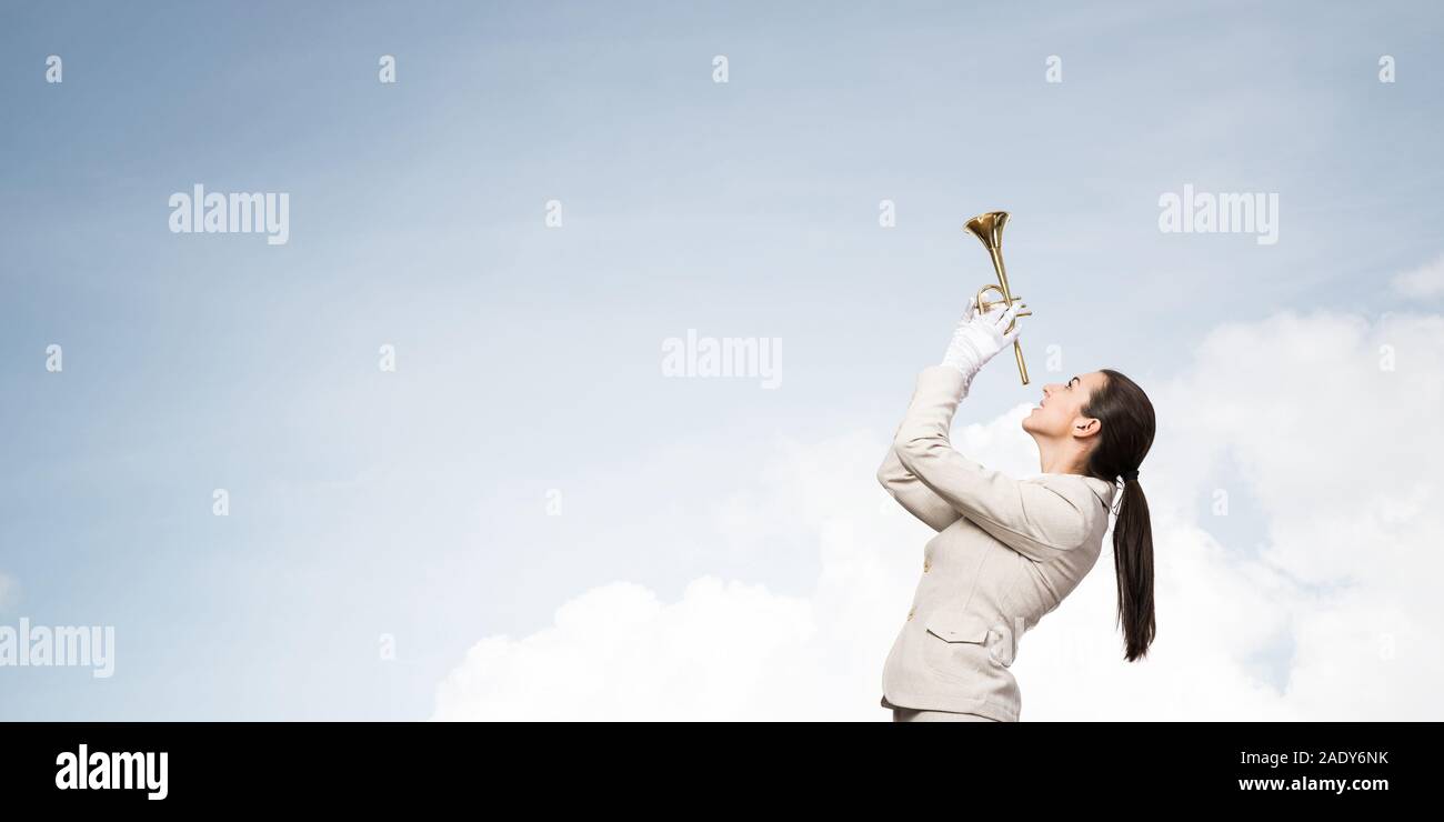 Beautiful woman playing trumpet brass Stock Photo - Alamy