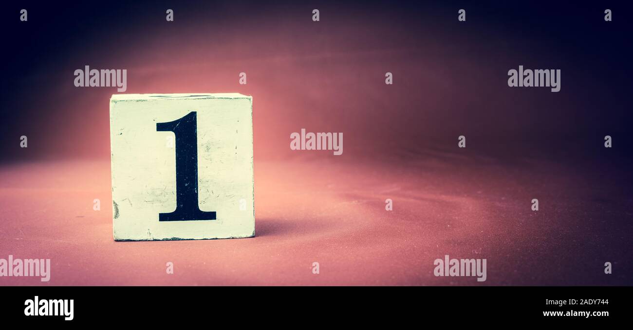 Old vintage wooden block with digit 1, number one - vivid maroon ...