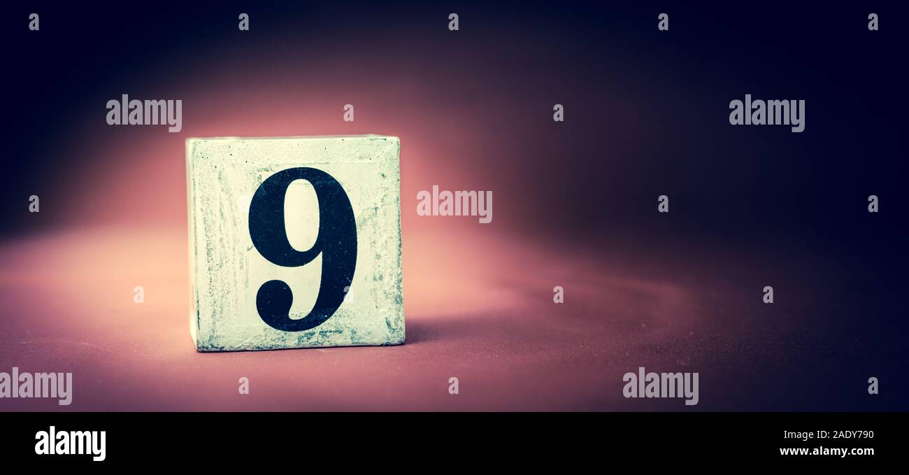 Old vintage wooden block with digit 9, number nine - vivid maroon ...