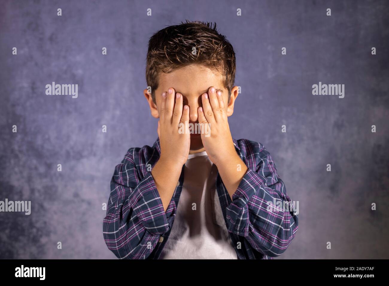 Little child covering his eyes with his hands Stock Photo - Alamy
