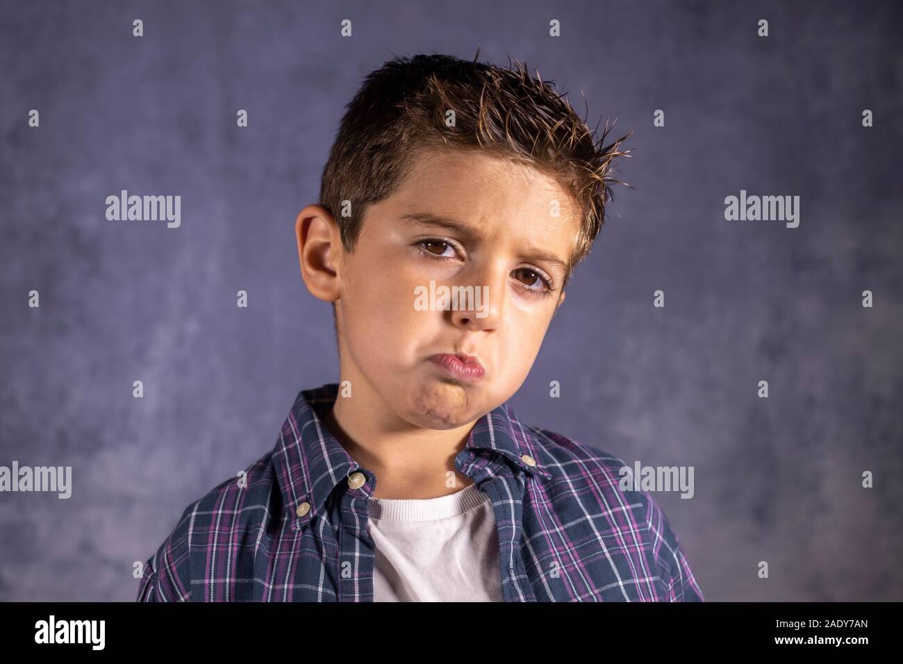 Little boy with a sad expression in his face Stock Photo - Alamy