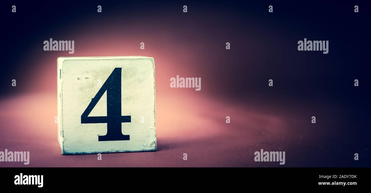 Old vintage wooden block with digit 4, number four - vivid maroon ...