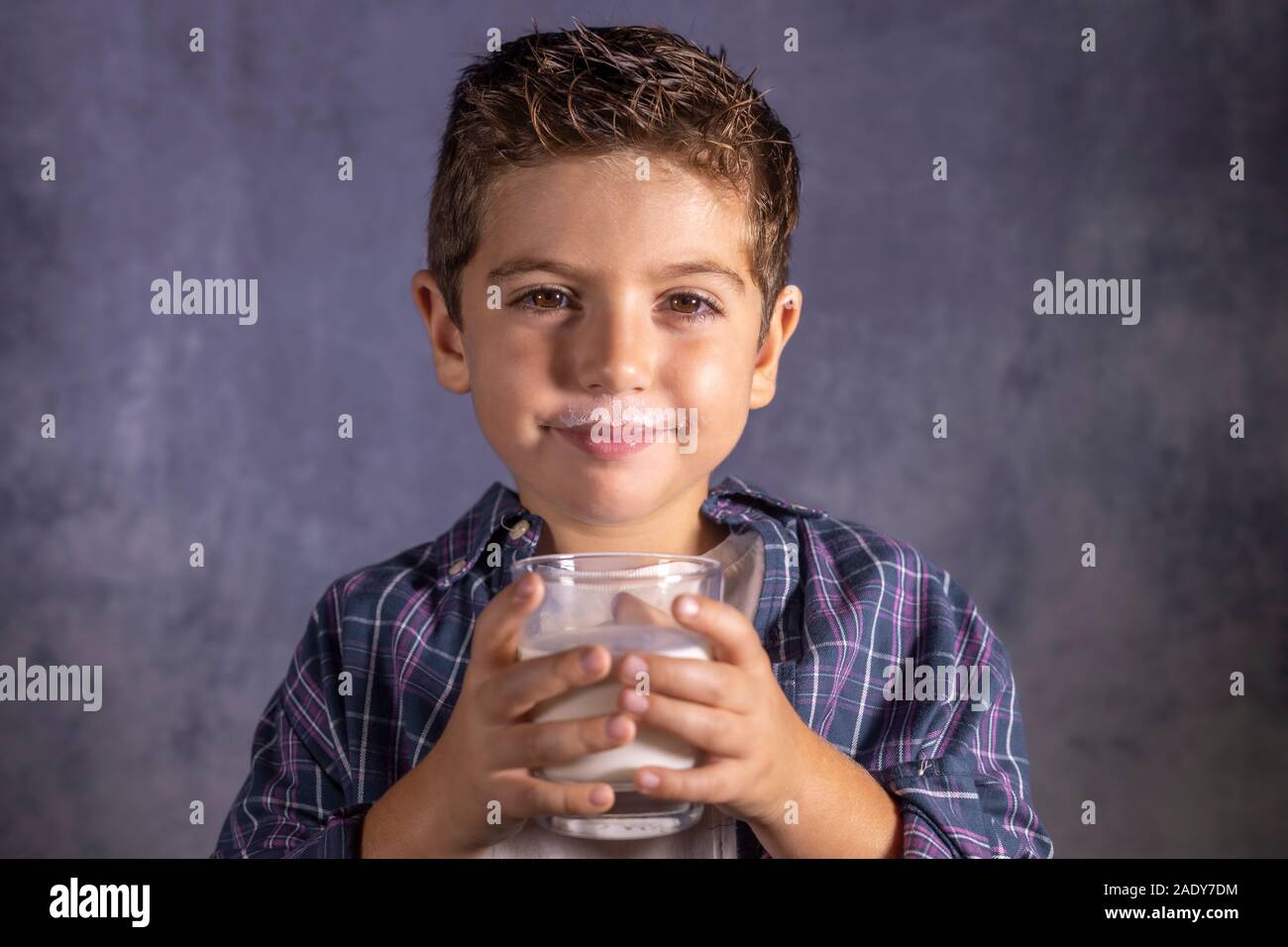Little child enjoying with a glass of milk Stock Photo - Alamy