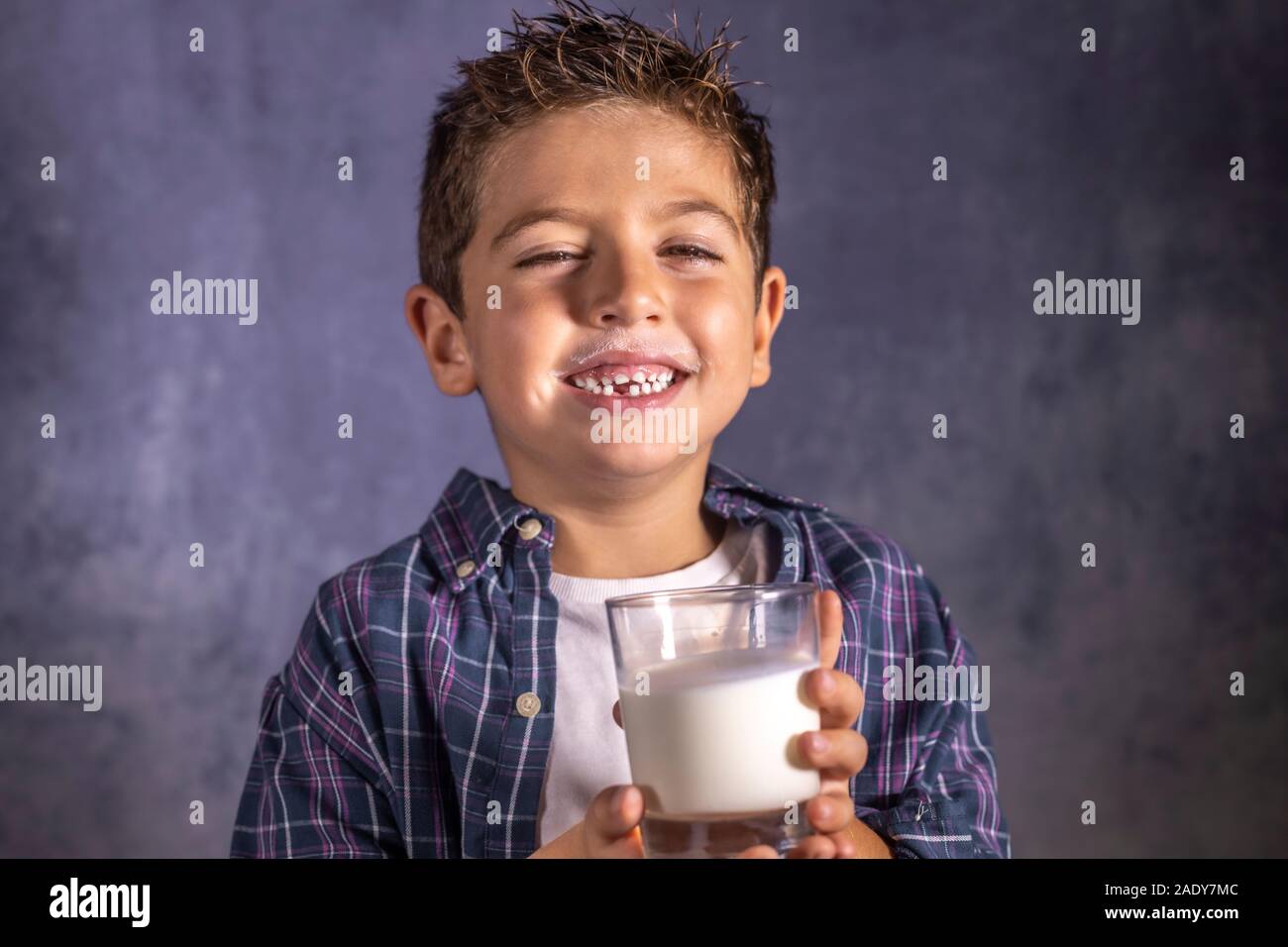 Little child enjoying with a glass of milk Stock Photo - Alamy