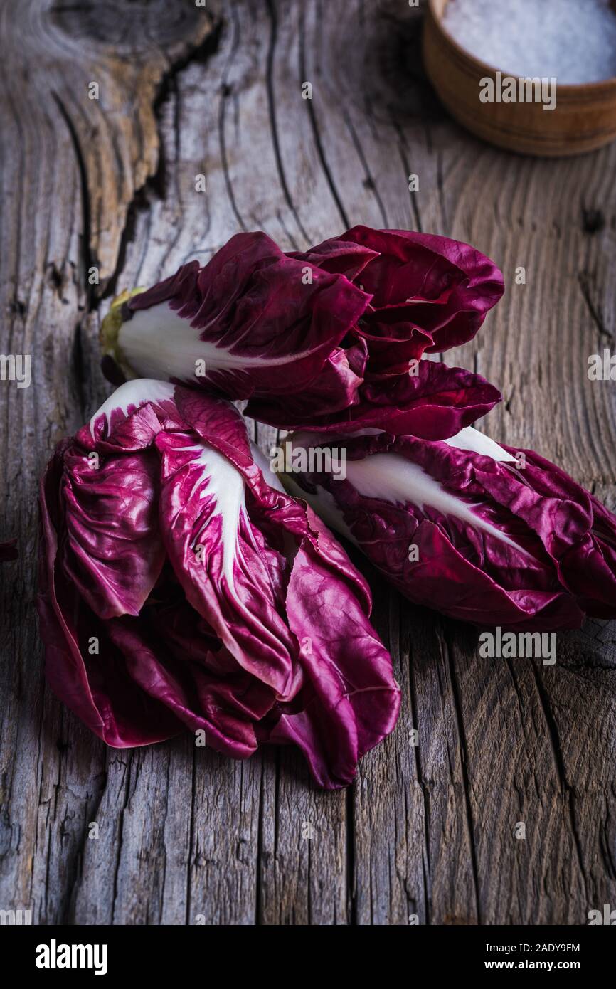 Fresh baby radicchio on wooden board. Healthy vegan plant based food on ...