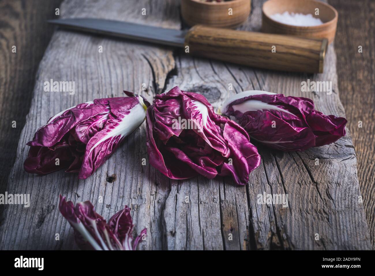 Fresh baby radicchio on wooden board. Healthy vegan plant based food on ...