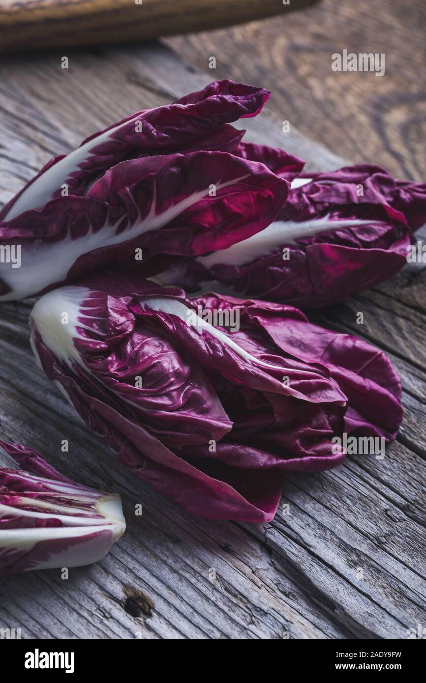 Fresh baby radicchio on wooden board. Healthy vegan plant based food on ...
