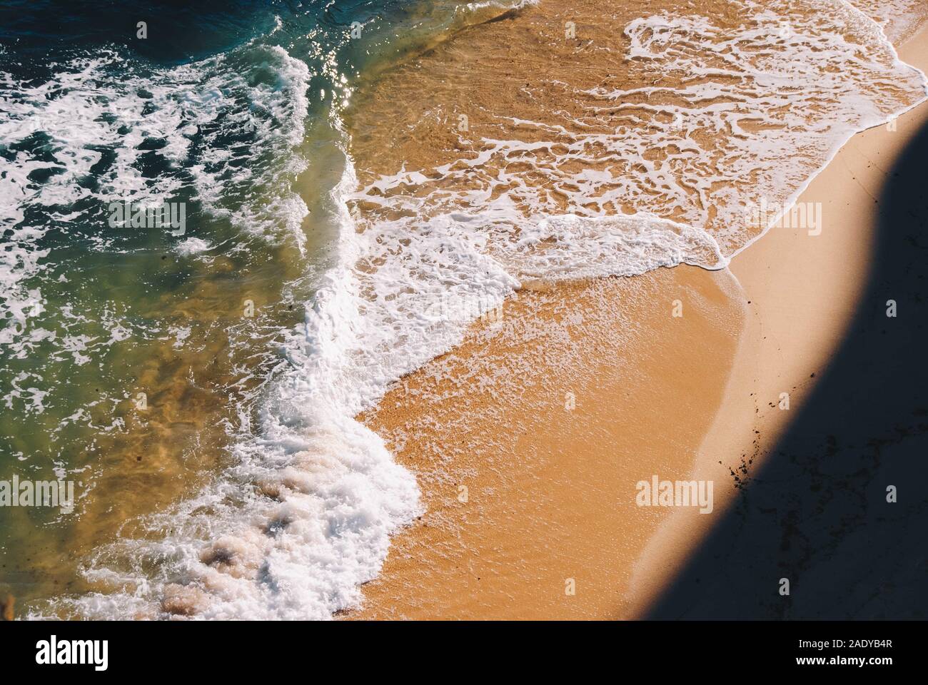 Wave returning to the sand Stock Photo - Alamy Wave returning to the sand Stock Photo - Alamy