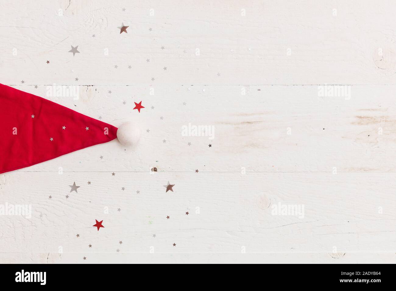 Top view on nice Santa's hat on wooden background with sparkling stars ...
