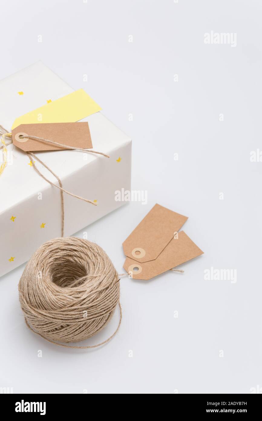 Nice present packed in white paper with small yellow stars on white ...
