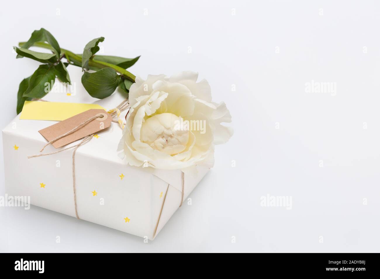 Nice present packed in white paper with small yellow stars with ...