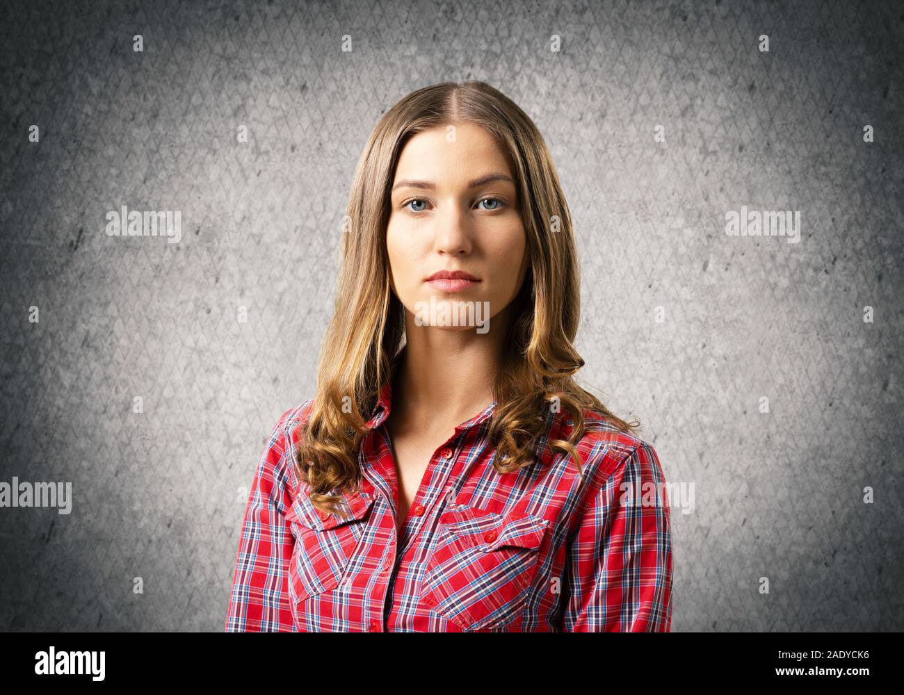 Young woman having serious and calm face Stock Photo - Alamy