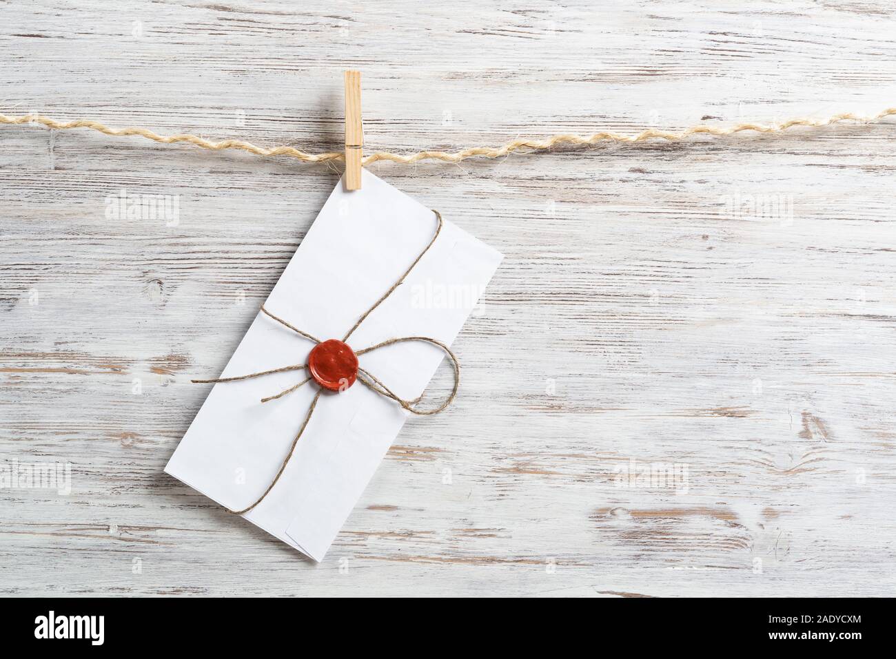 White envelope hanging on rope Stock Photo - Alamy
