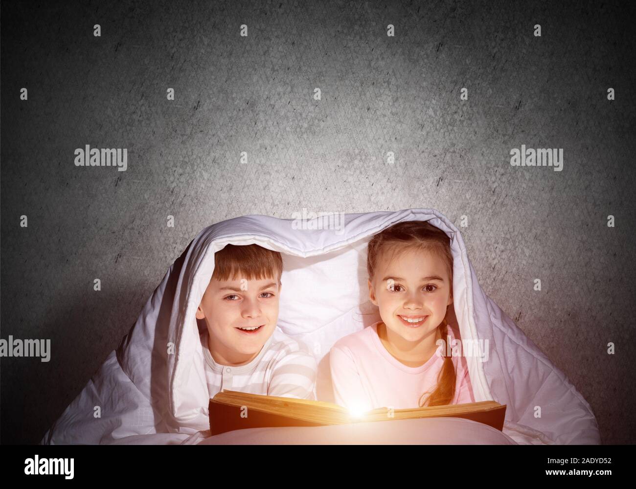 Happy children with flashlight hiding Stock Photo - Alamy