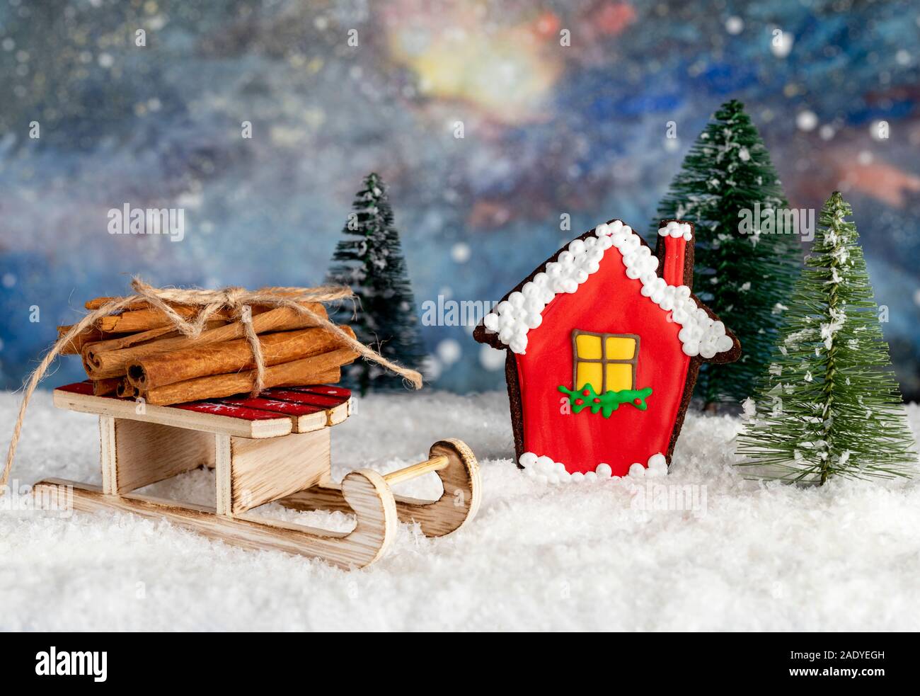 Gingerbread house, Santas sleigh with cinnamon firewood and three fir ...