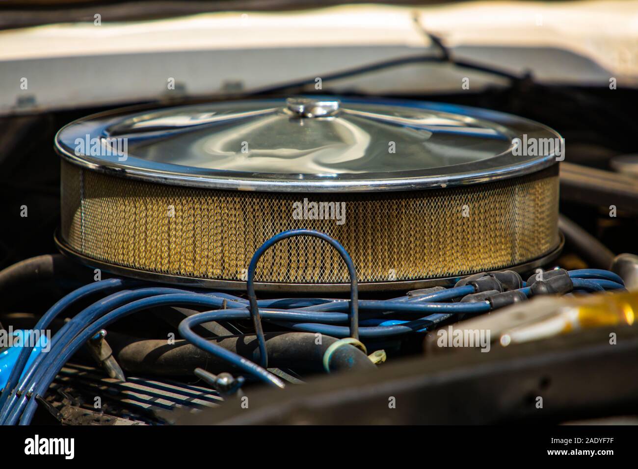 Close up and selective focus on big chromed round air intake filter on ...