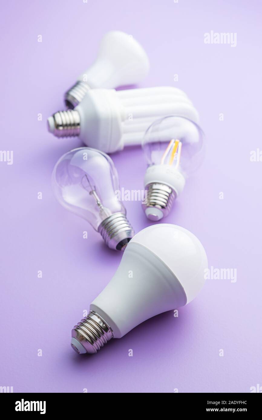 Energy saving and classic light bulbs on violet background Stock Photo ...