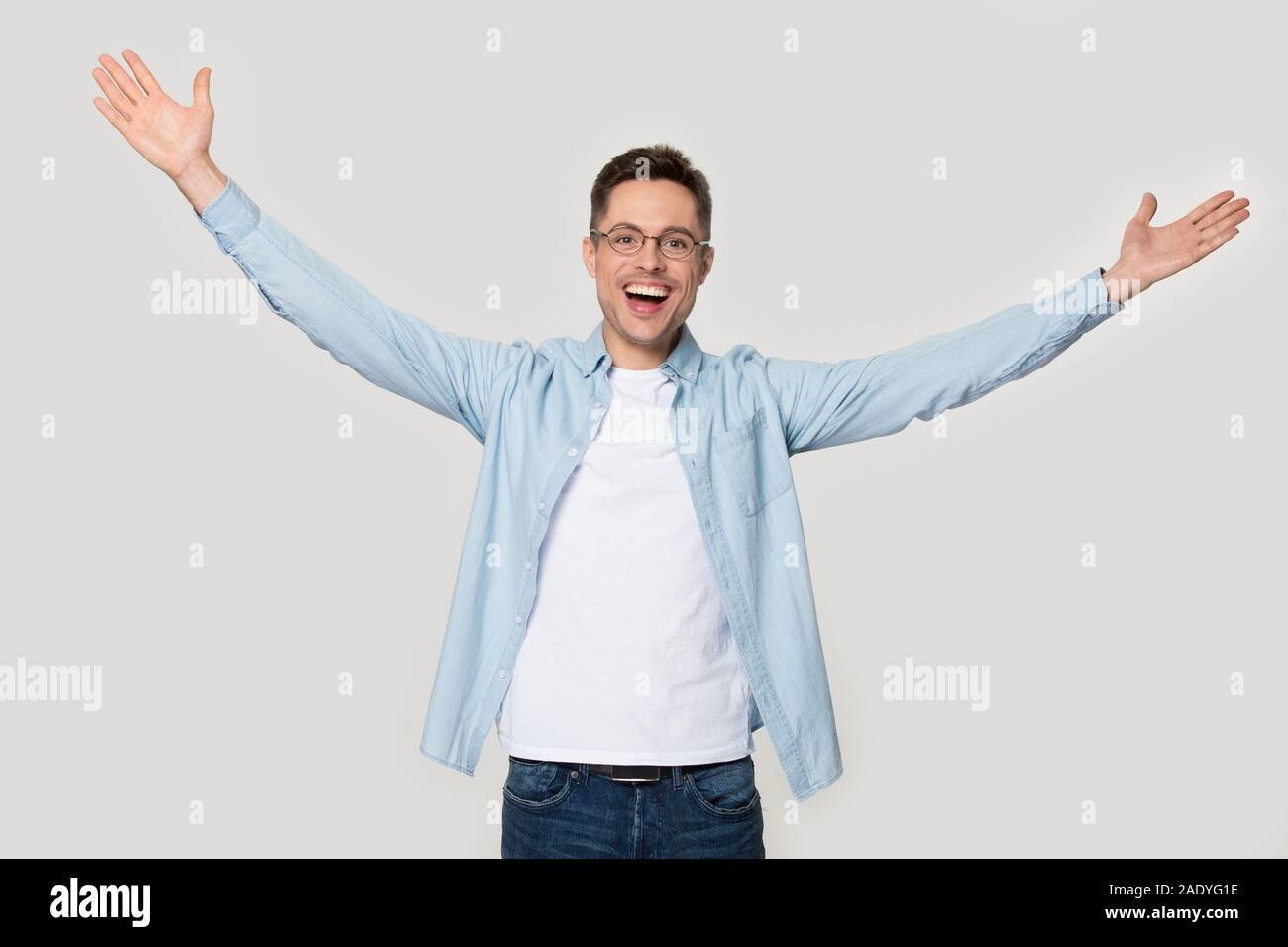 Overjoyed happy man standing with his hands wide open Stock Photo - Alamy