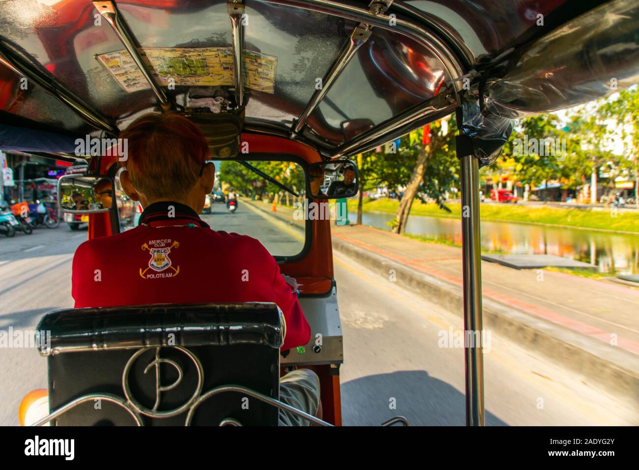 Asian man driving a tuk tuk around the streets of chiang mai Stock ...