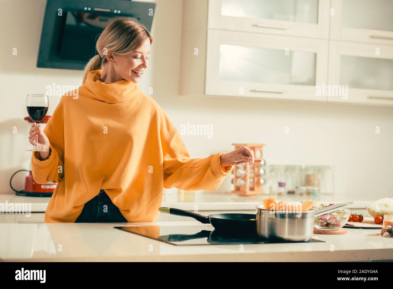 Woman adding salt to food hi-res stock photography and images - Alamy