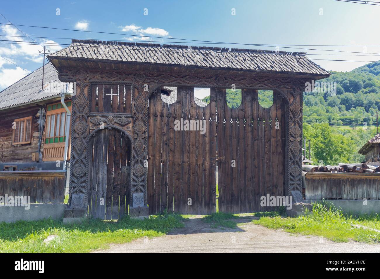 Traditional, wooden gates with different patterns in the village of ...