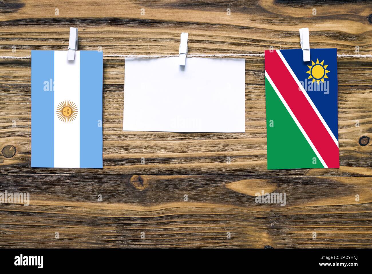 Hanging flags of Argentina and Namibia attached to rope with clothes ...