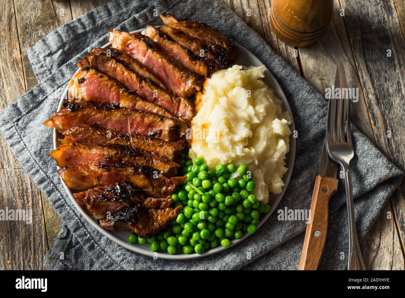 Homemade Grilled Sugar Steak with Potatoes and Peas Stock Photo - Alamy
