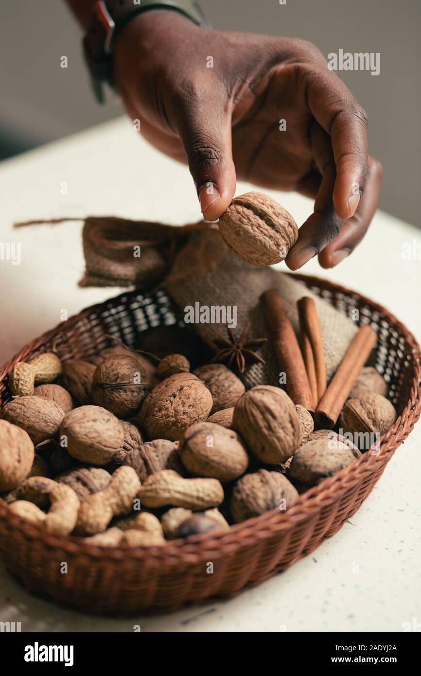 Close up of person putting walnut into the basket Stock Photo - Alamy