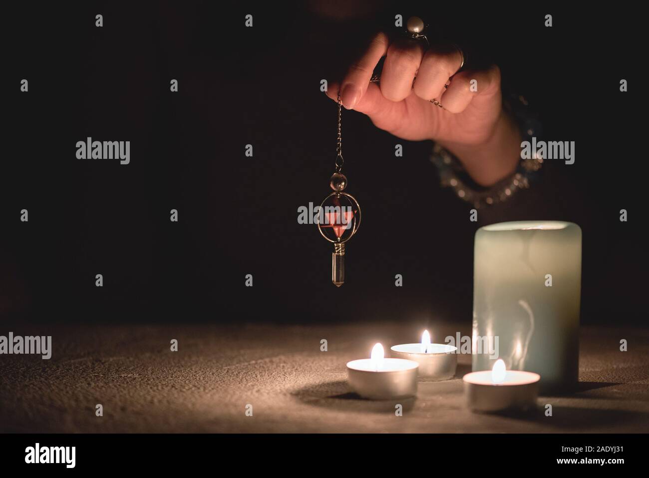 Fortune teller holding in hands a magic pendulum close up Stock Photo ...