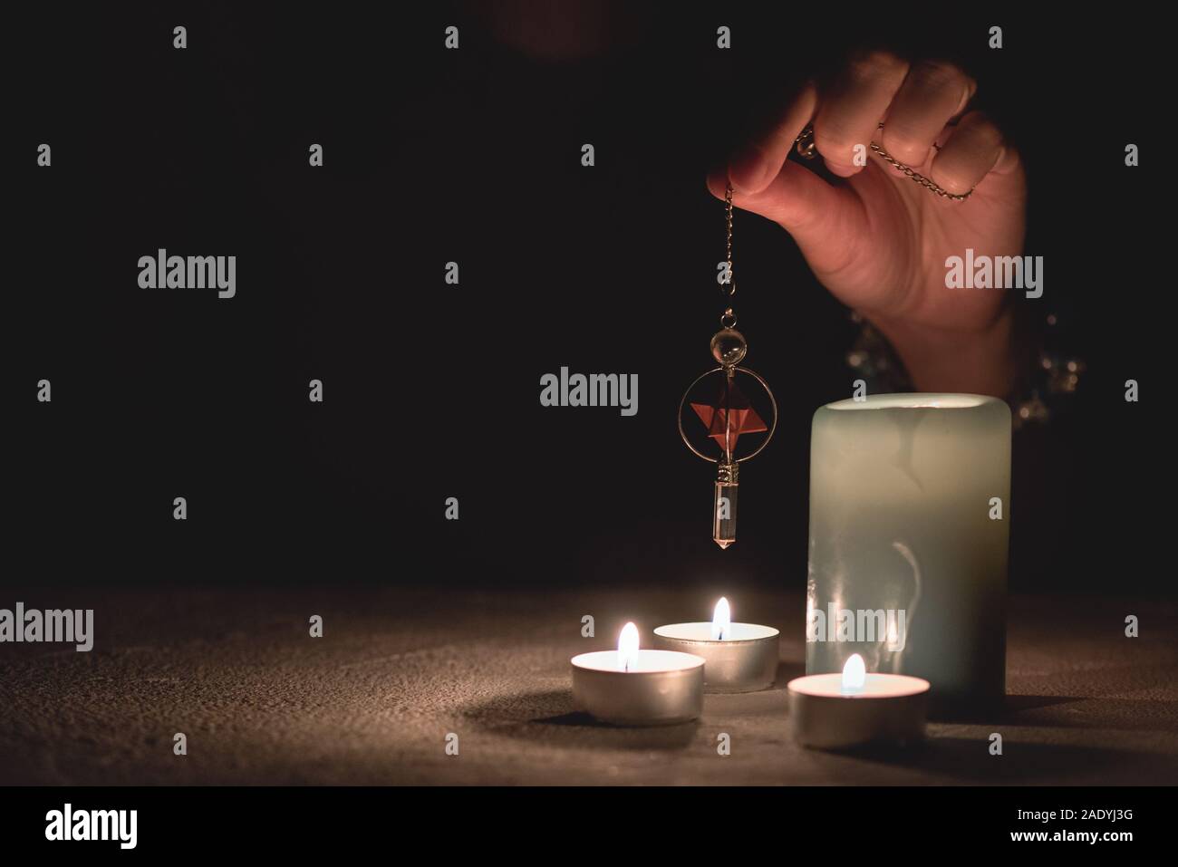 Fortune teller holding in hands a magic pendulum close up Stock Photo ...