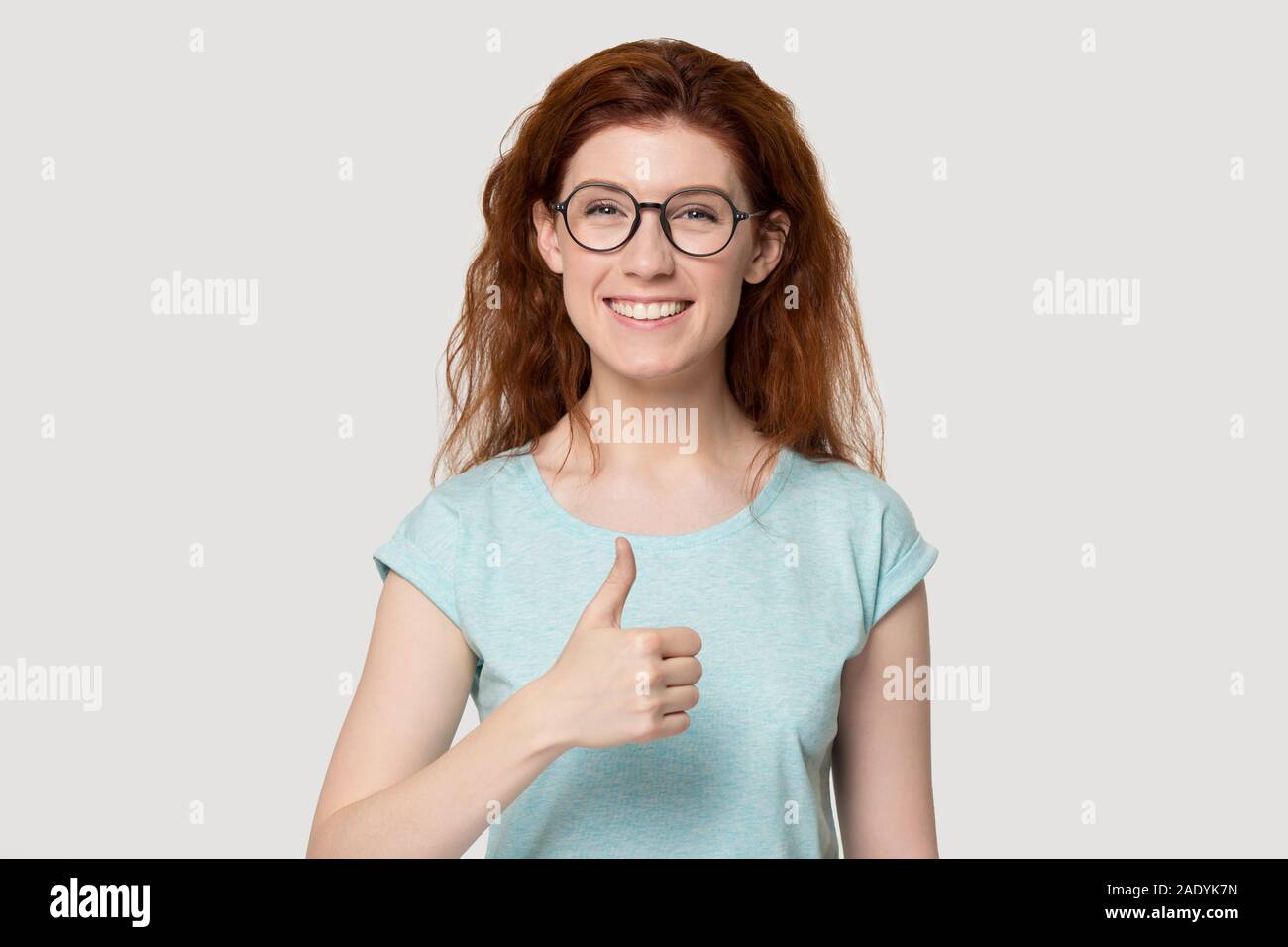 Young happy smiling woman showing thumbs up gesture Stock Photo - Alamy