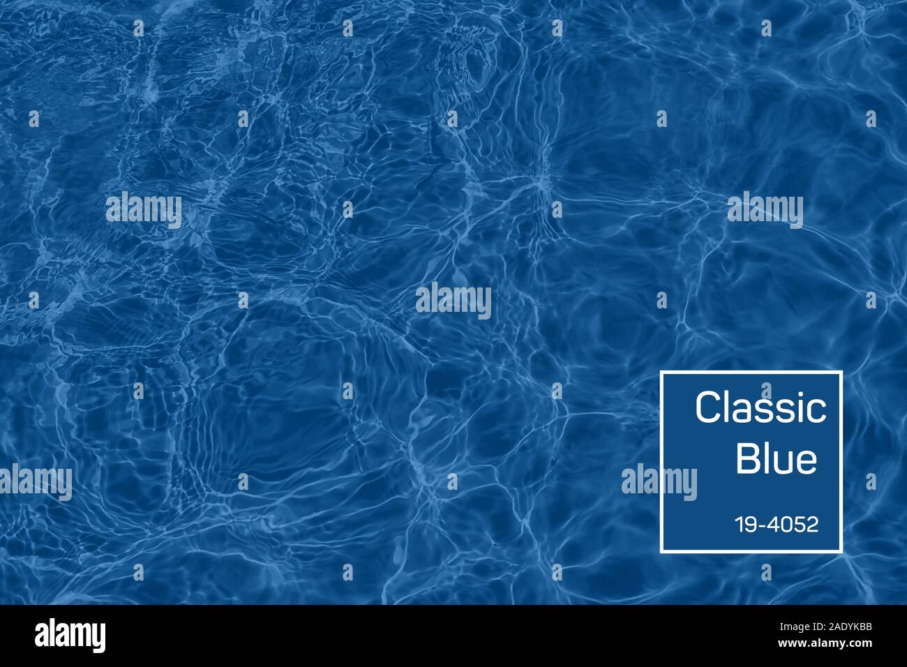 Closeup of calm clear water surface with water splashes in trendy blue ...