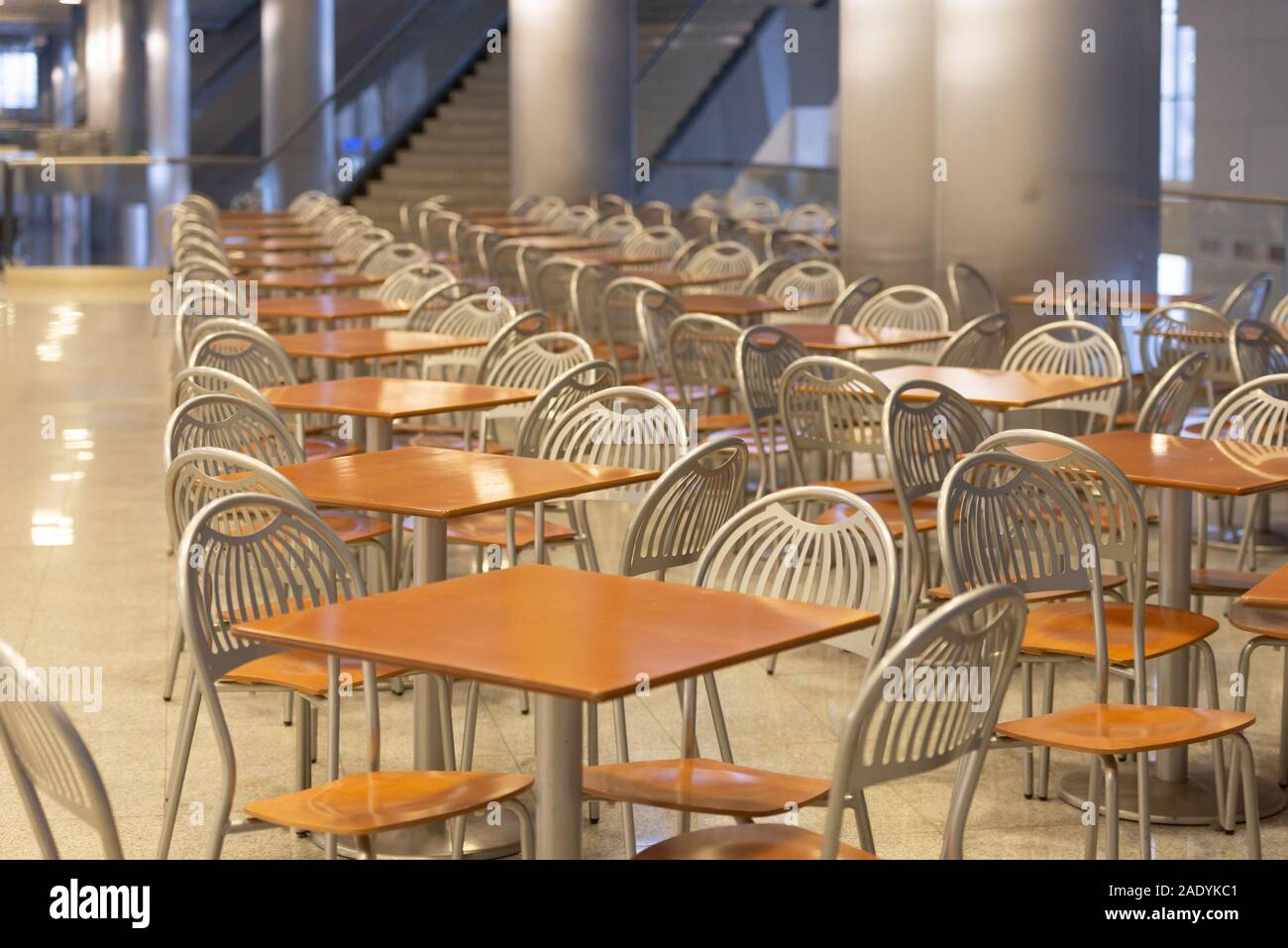 A long row of tables from the cafeteria in the lobby of the building ...