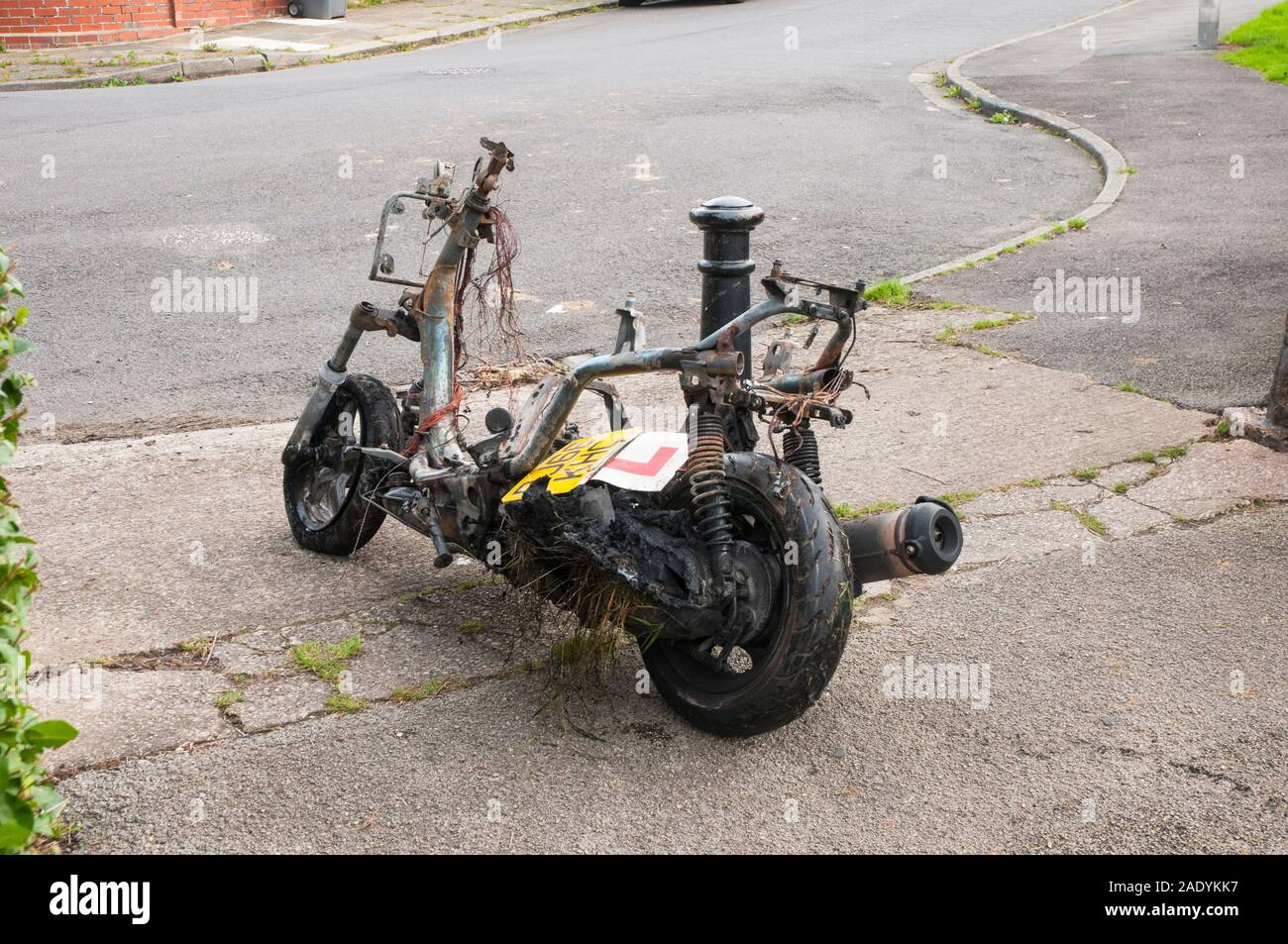 Burnt out motor scooter waiting to be loaded onto recovery truck Stock ...