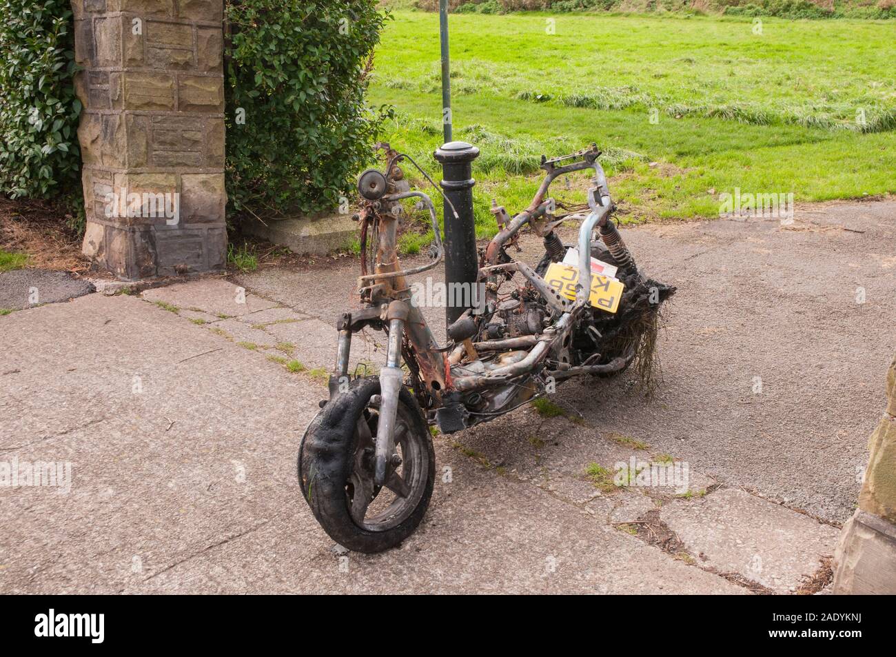 Burnt out motor scooter waiting to be loaded onto recovery truck Stock ...