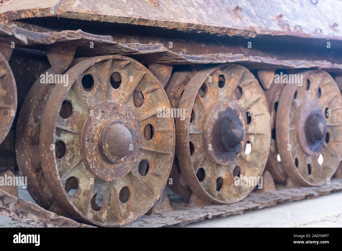 Old rusty caterpillar. Huge rusty wheels closeup. This tank had been in ...