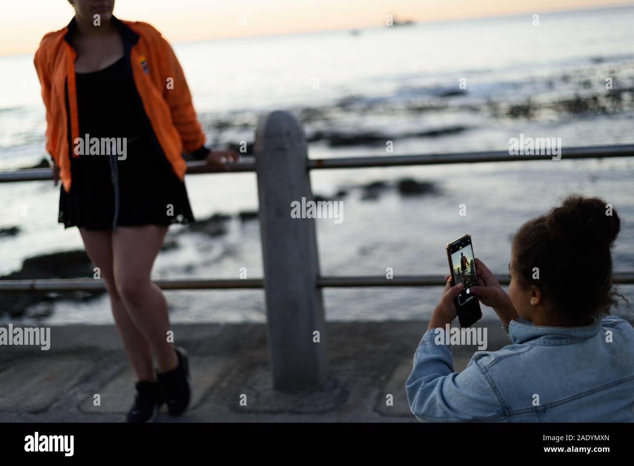 Friends take pictures with cellphones along the Greenpoint promenade in ...