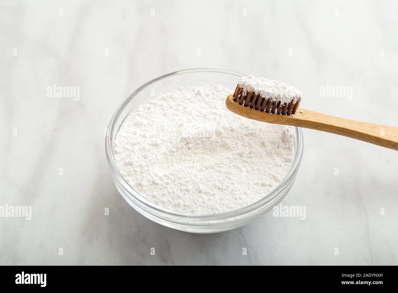 Bamboo toothbrush, dentifrice tooth powder on white marble background ...
