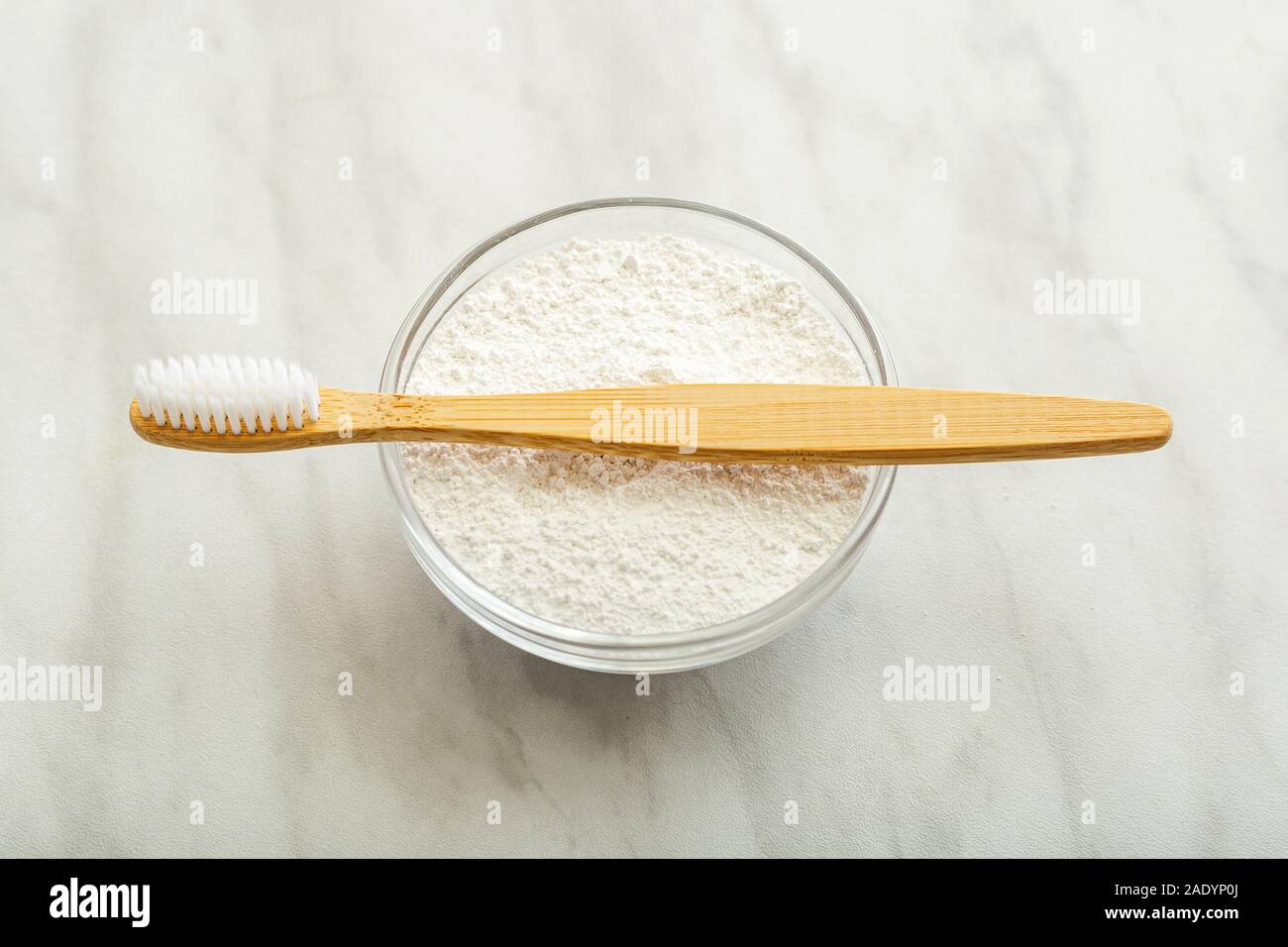 Bamboo toothbrush, dentifrice tooth powder on white marble background ...