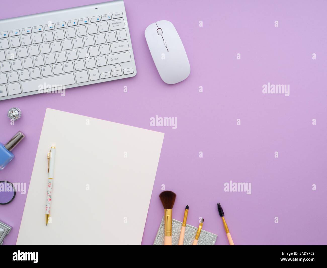 Keyboard and makeup tools and cosmetic products around it a paper note ...