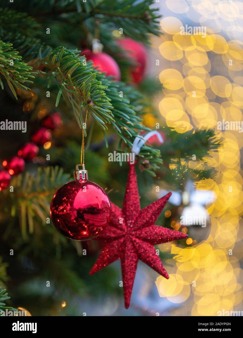 Red toys at Christams fir tree - balls and stars . City lights at ...