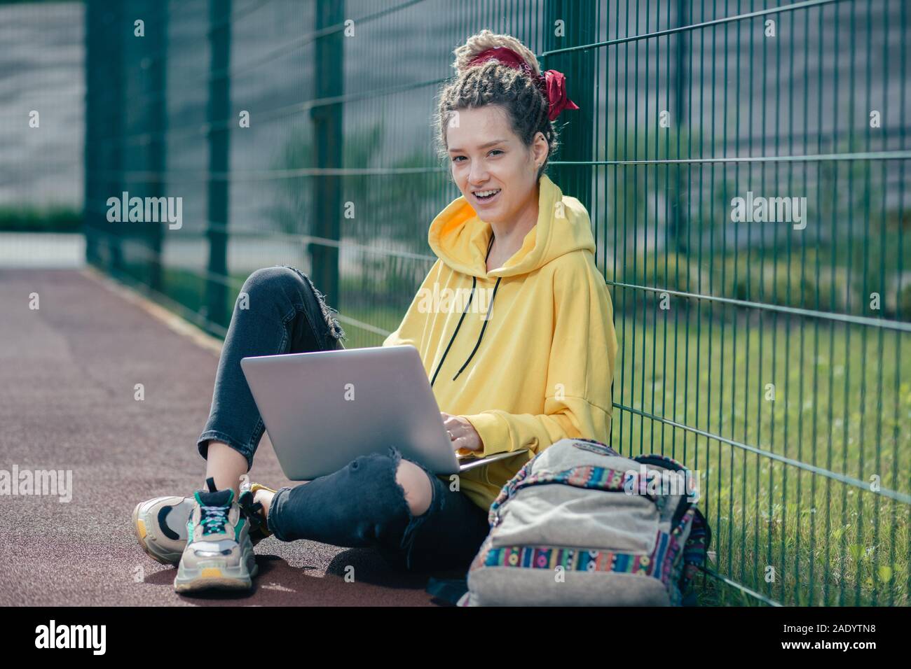 Emotional lady feeling happy while sitting with her laptop Stock Photo ...