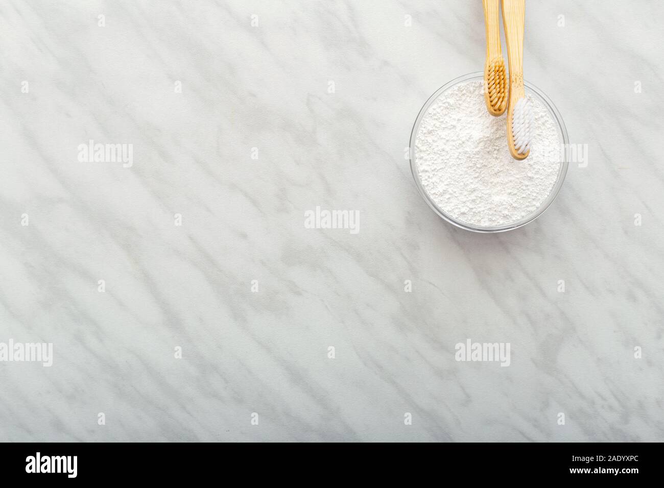 Bamboo toothbrush, dentifrice tooth powder on white marble background ...