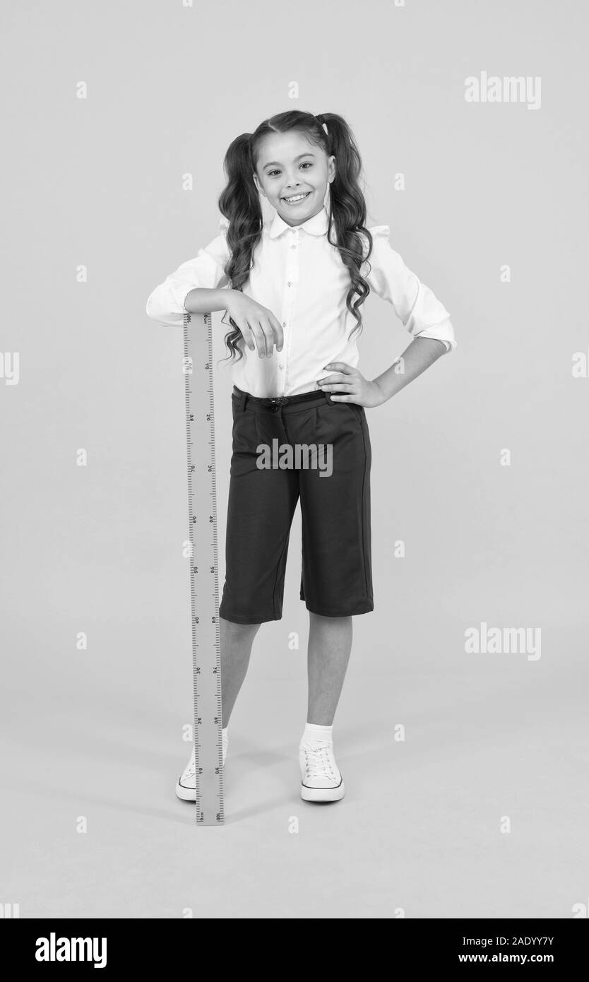 Time for learning. Small school child with ruler learning maths and ...